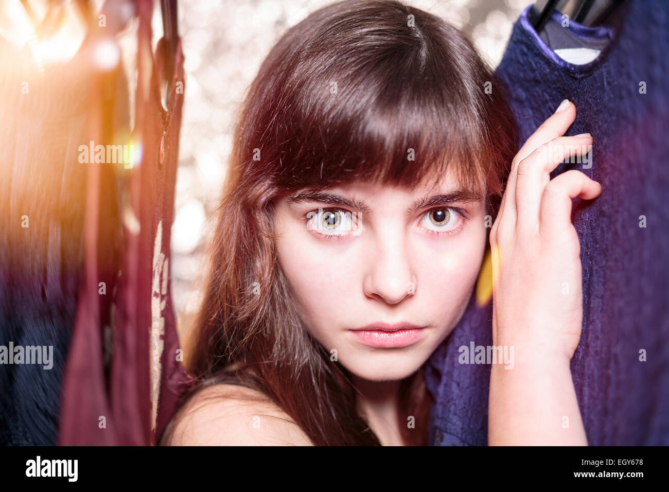 beautiful teenage girl with intense look, bokeh, flare, motion blur ...
