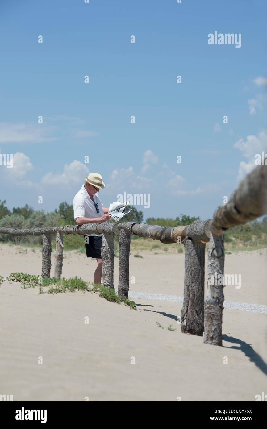 Man reading newspaper on beach hi-res stock photography and images - Alamy