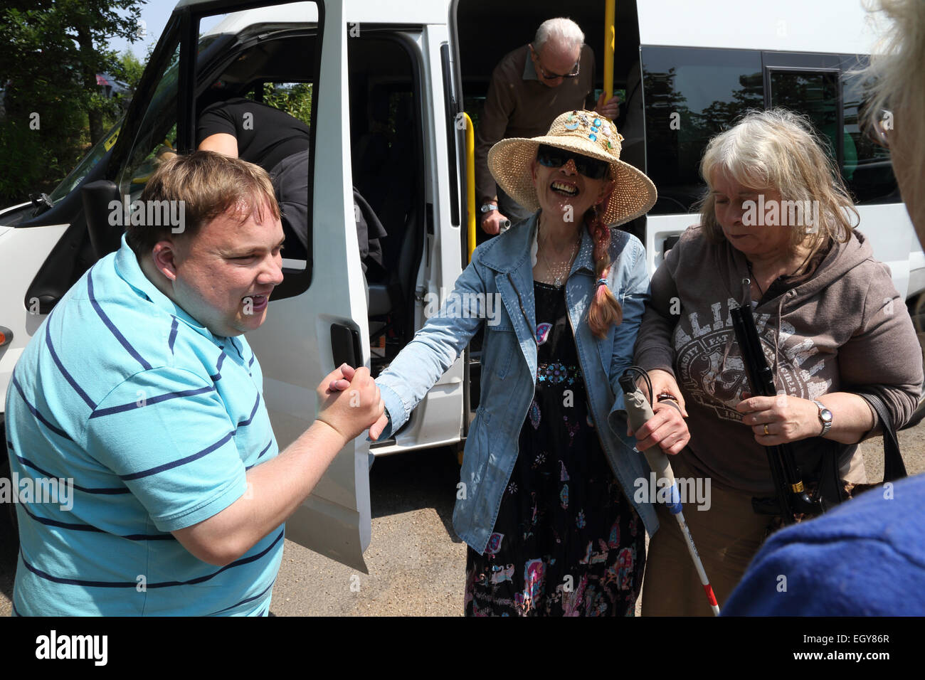 People with visual impairments getting off a minibus Stock Photo - Alamy