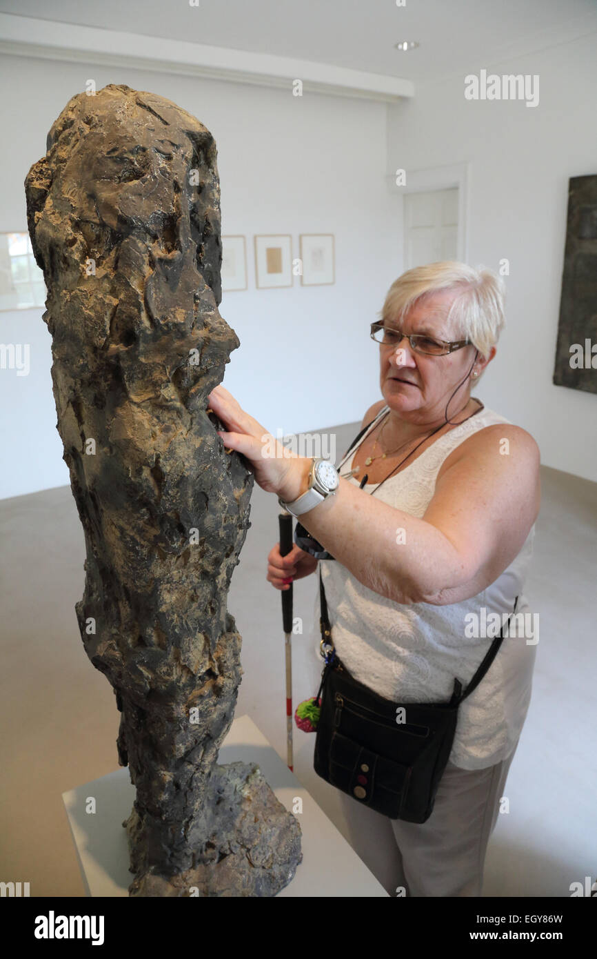Woman with visual impairment touching a sculpture at Yorkshire ...