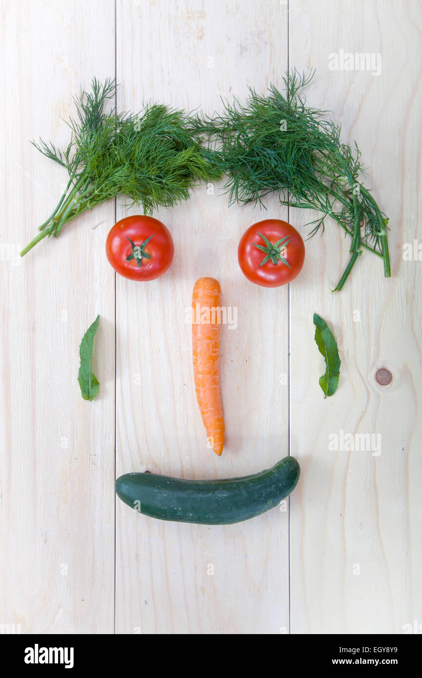Mix of fresh vegetables arranged like smiling face Stock Photo - Alamy