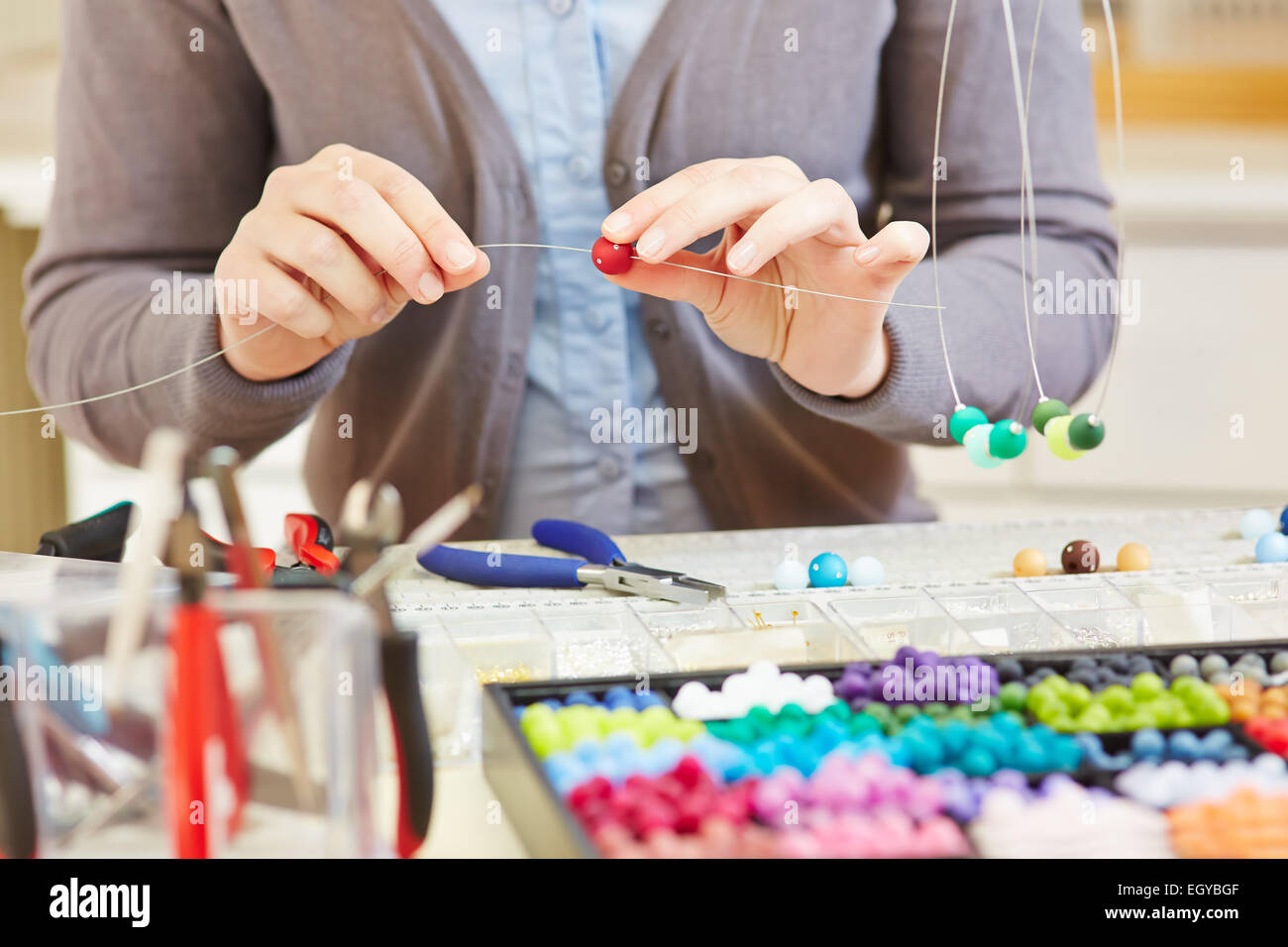 Artisan in workshop creating a necklace for a jewelry store Stock Photo ...
