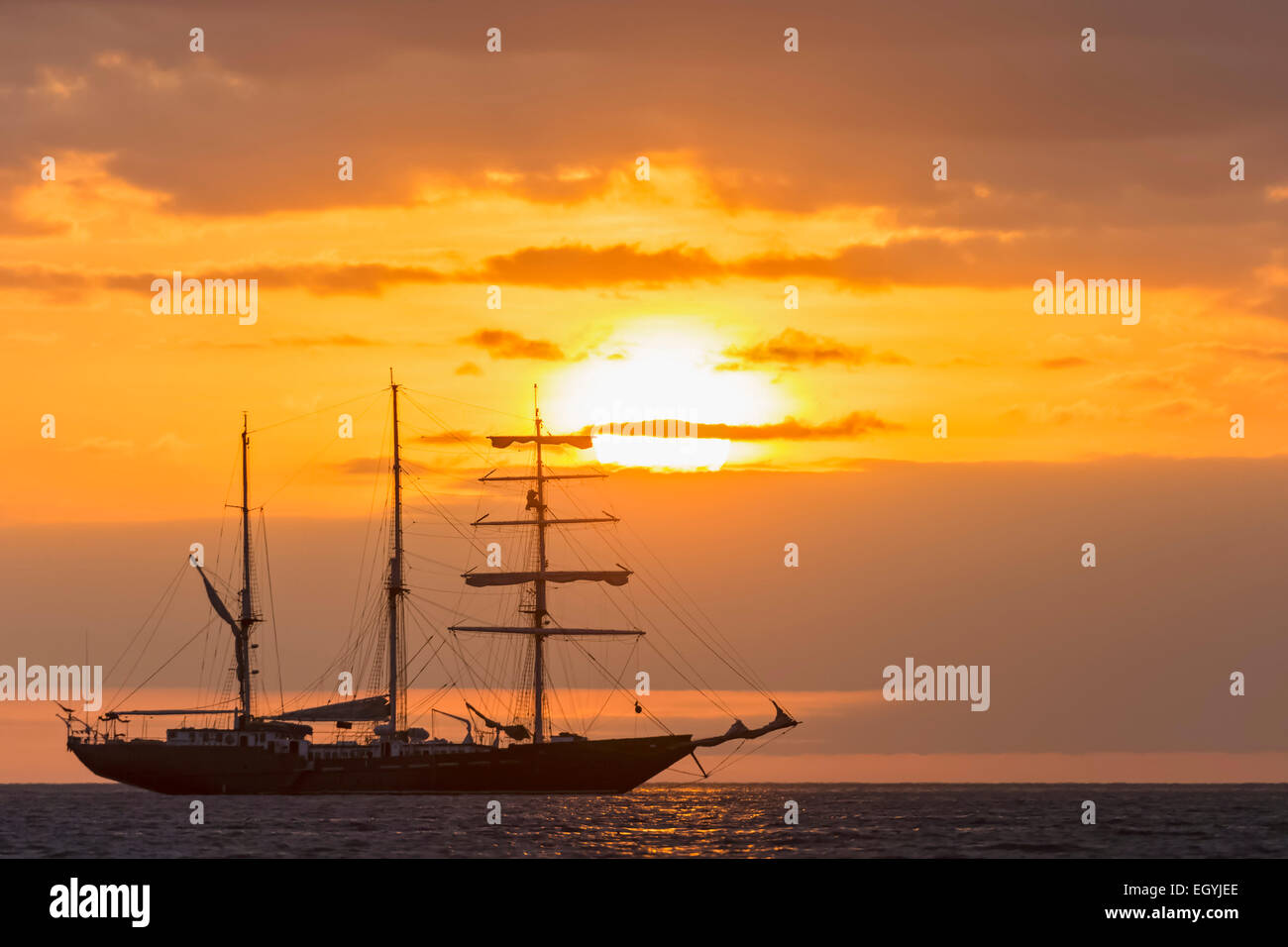 Pacific Ocean, sailing ship at Galapagos Islands at sunset Stock Photo ...