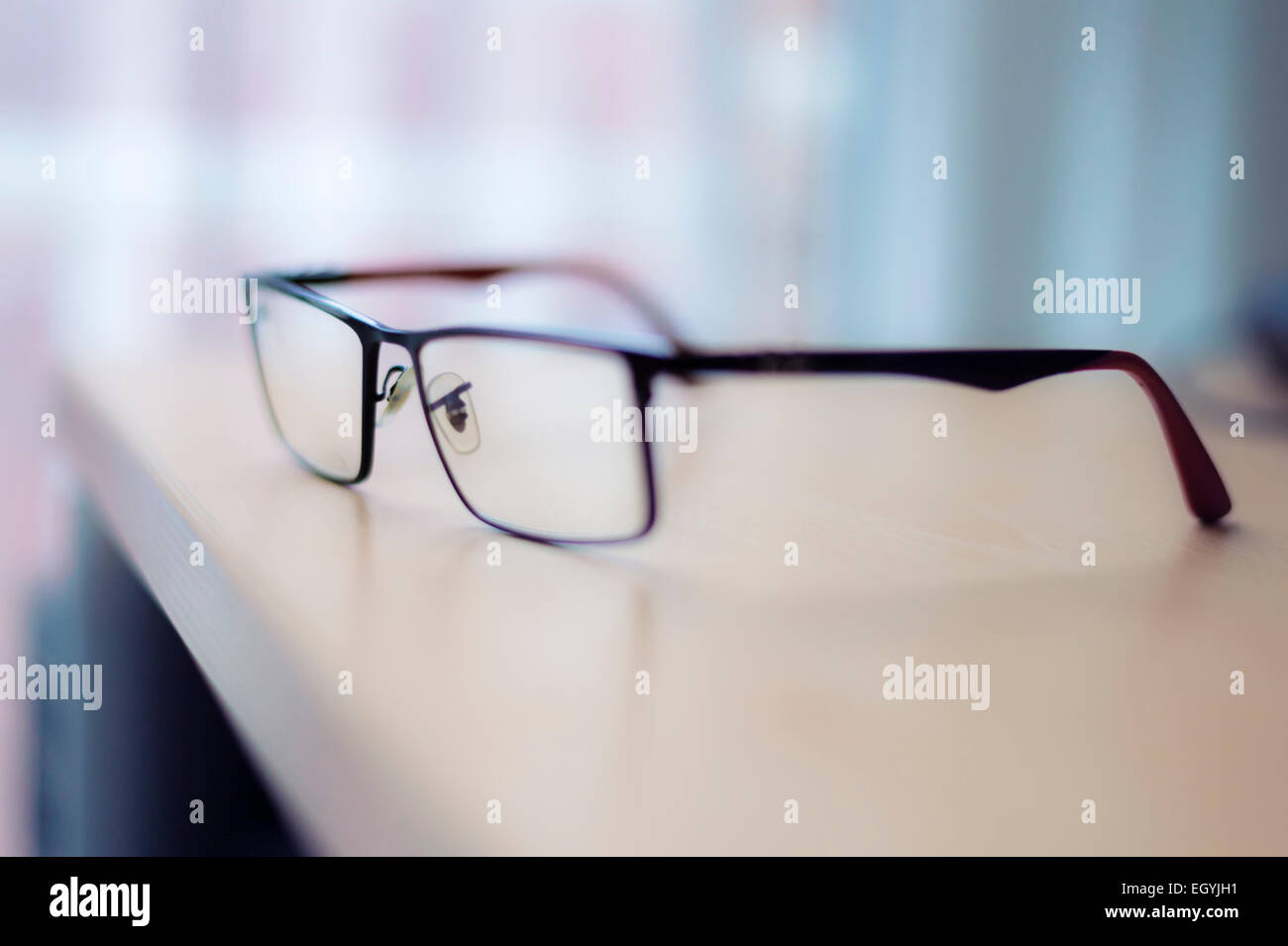 Spectacles on desk Stock Photo - Alamy