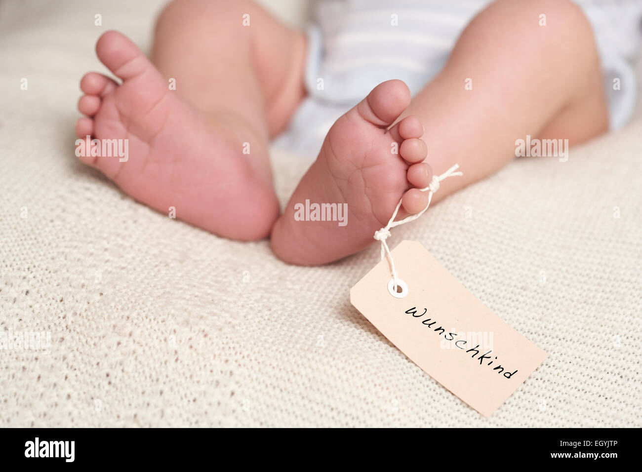 Baby's feet with 'planned child' written on cardboard sign Stock Photo ...