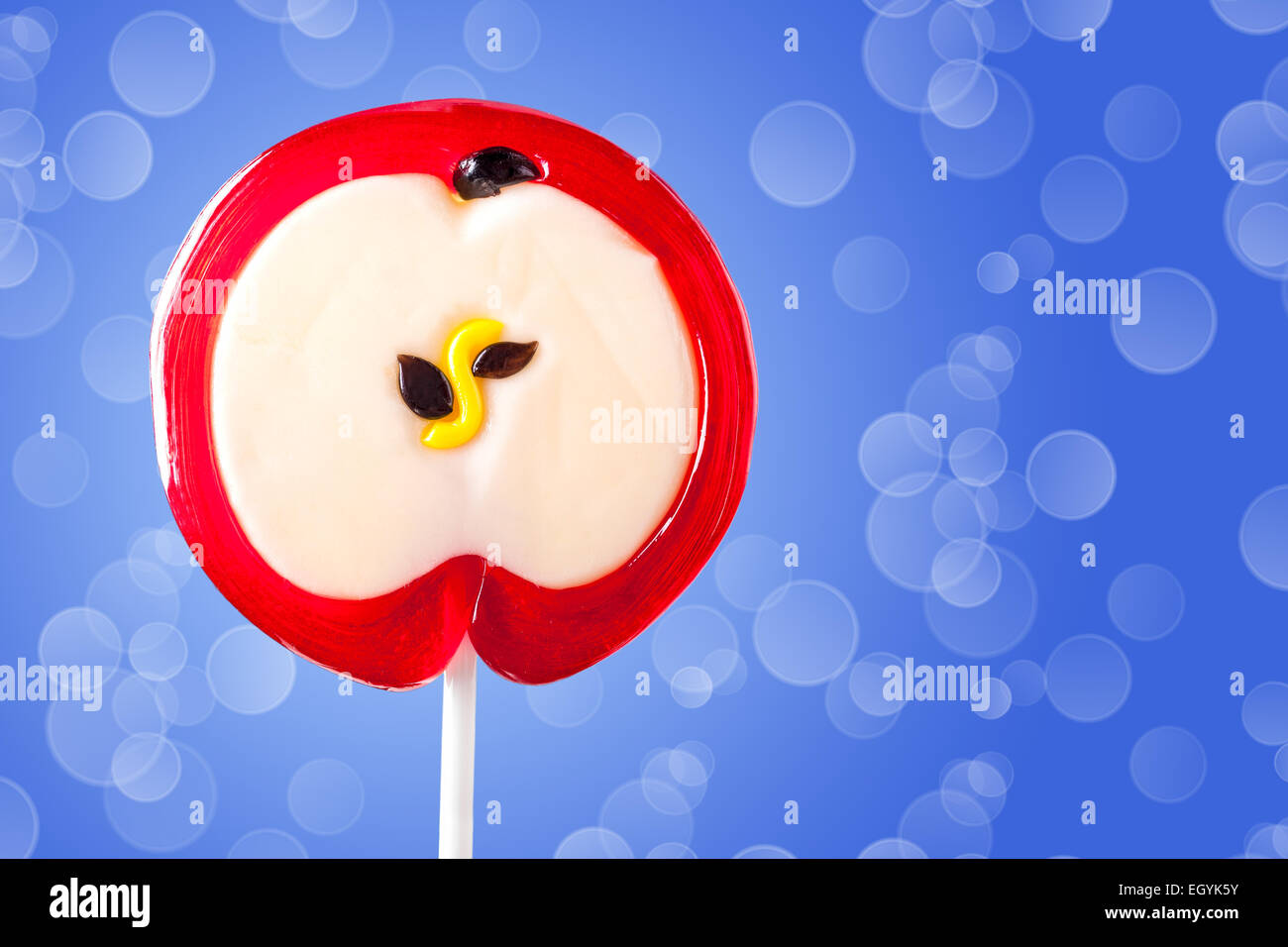 lollipop in the form of an apple on a blue background Stock Photo - Alamy