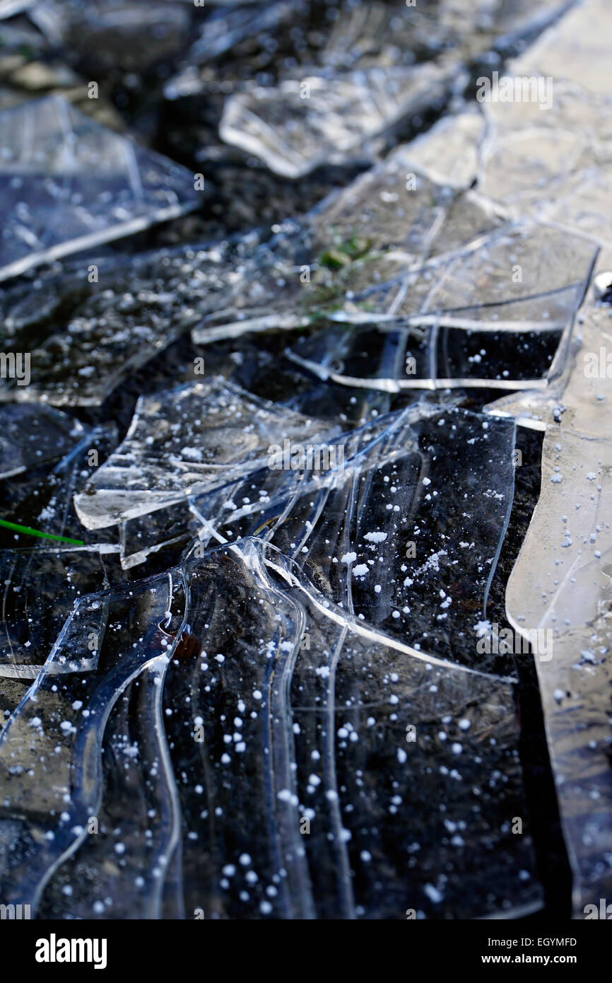 Broken ice on a puddle Stock Photo - Alamy