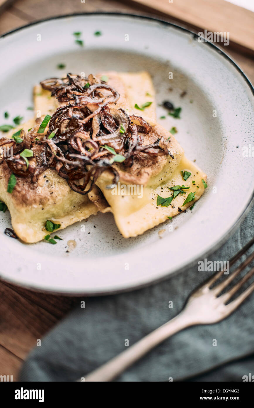 Vegetable ravioli fried in butter with roasted onions Stock Photo - Alamy
