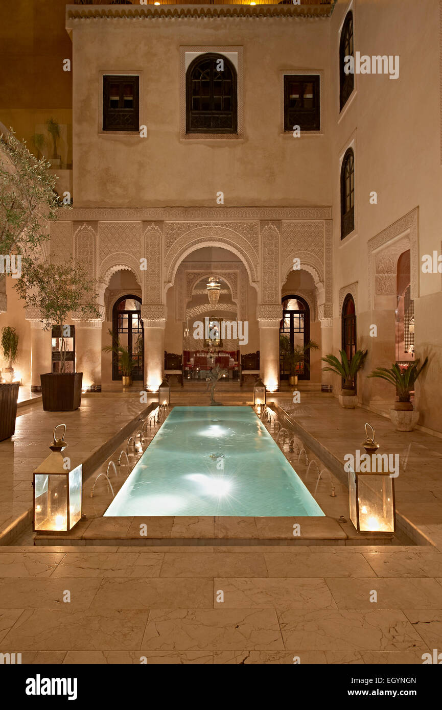 Morocco, Fes, Hotel Riad Fes, courtyard with lightened pool by night ...