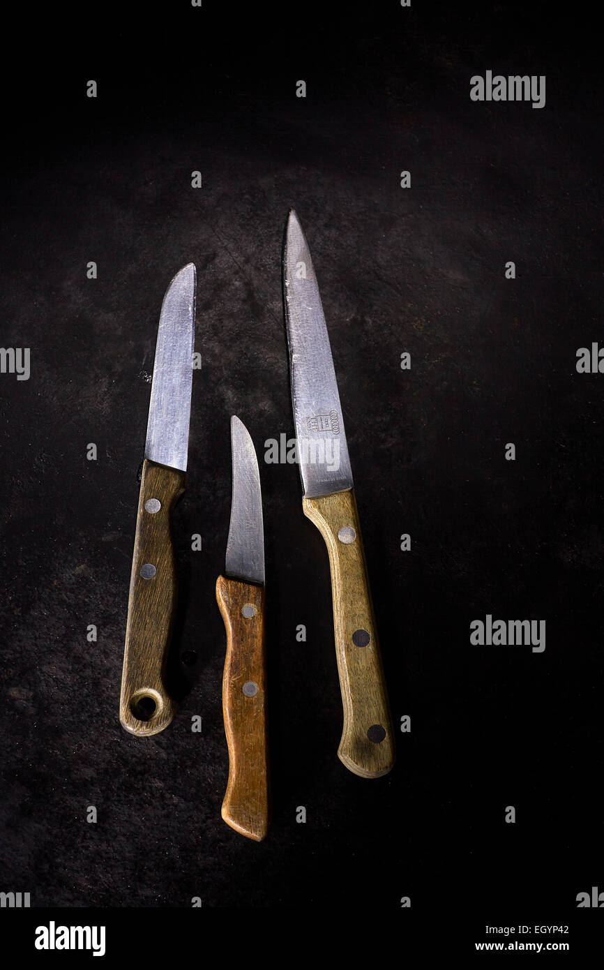Three kitchen knives on dark ground Stock Photo - Alamy