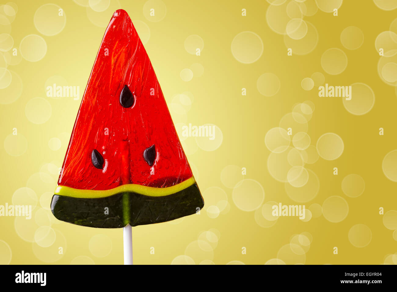 lollipop in the form of a watermelon on a yellow background Stock Photo ...