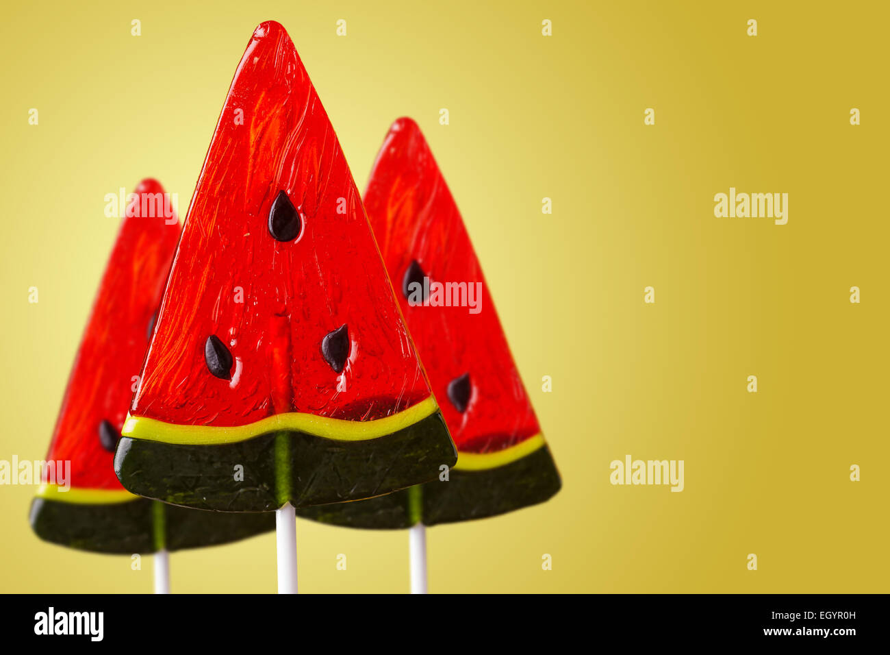 lollipop in the form of a watermelon on a yellow background Stock Photo ...