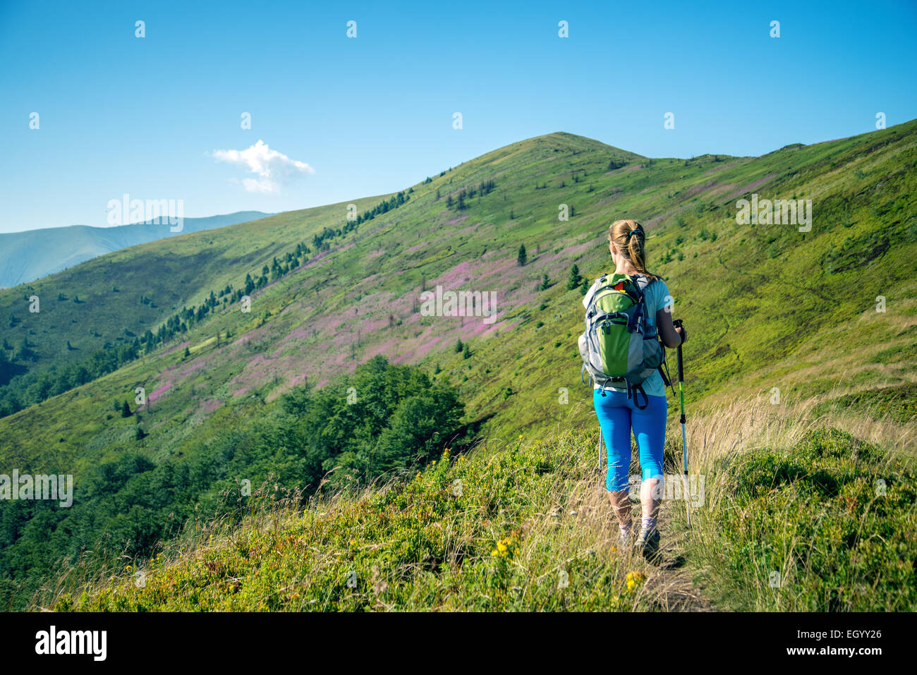 Young woman hiking in the mountains Stock Photo - Alamy