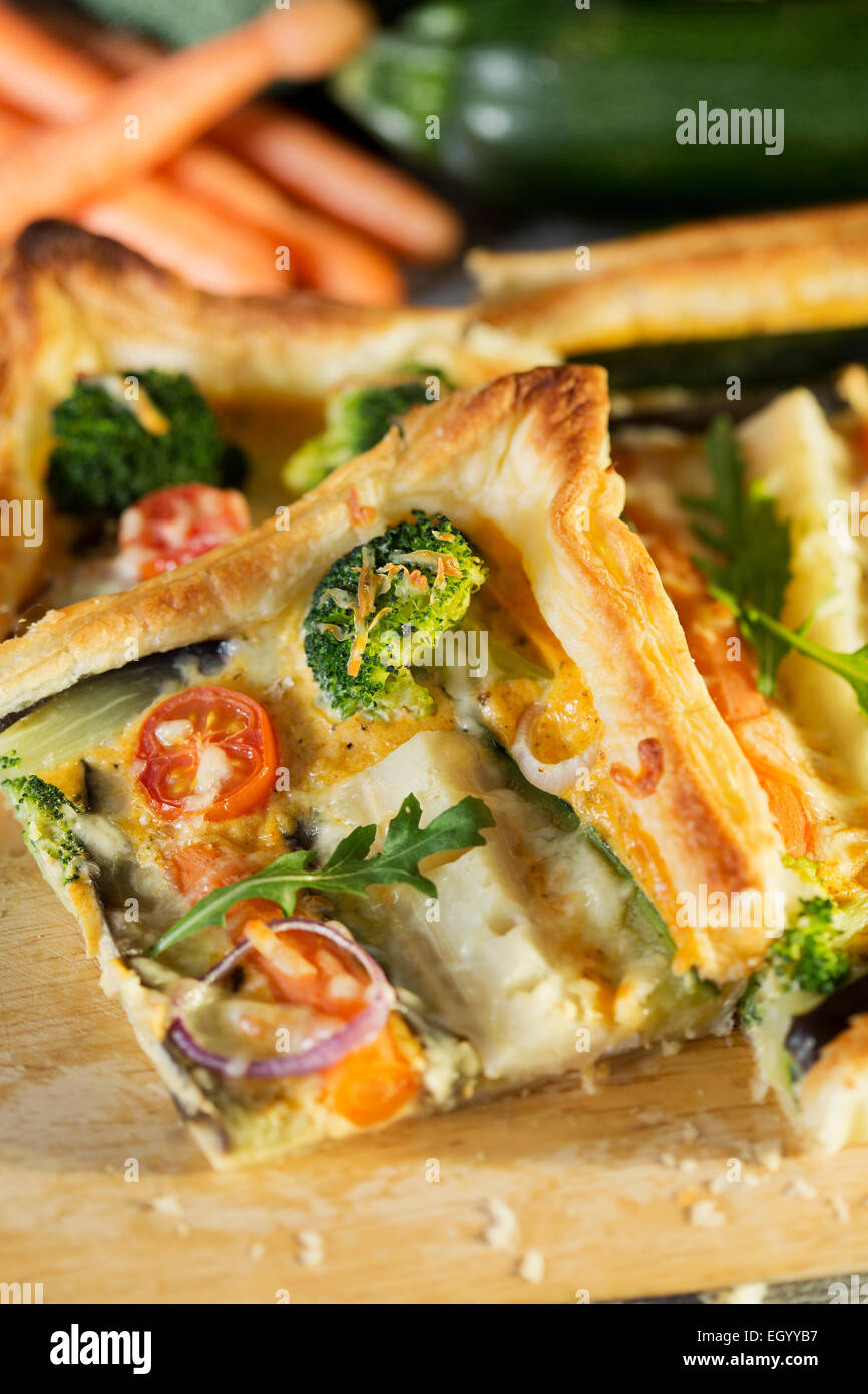 Piece of vegetarian quiche with different vegetables Stock Photo - Alamy