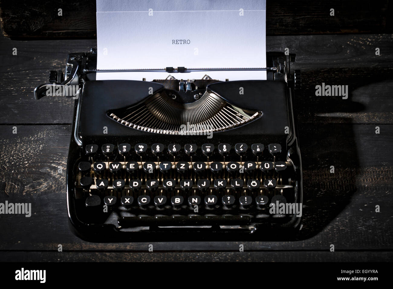 Old black typewriter on dark wood Stock Photo - Alamy