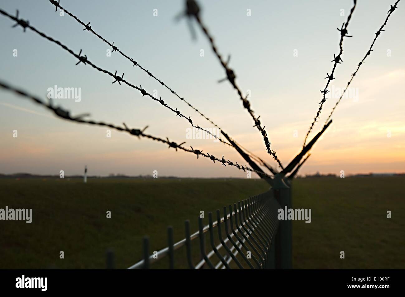 Security fence barb wire sunset hi-res stock photography and images - Alamy