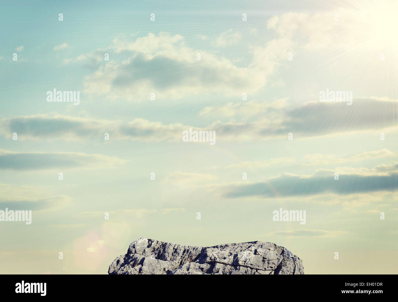 Stone on background of sky, sun Stock Photo - Alamy