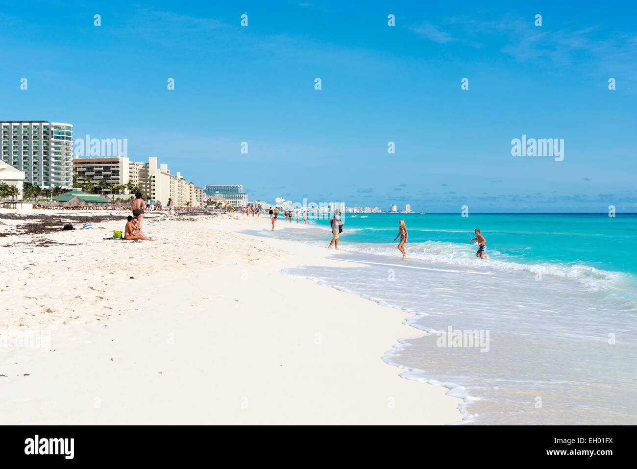 Tourists enjoy the sunny weather and relaxing on the beautiful beach in ...