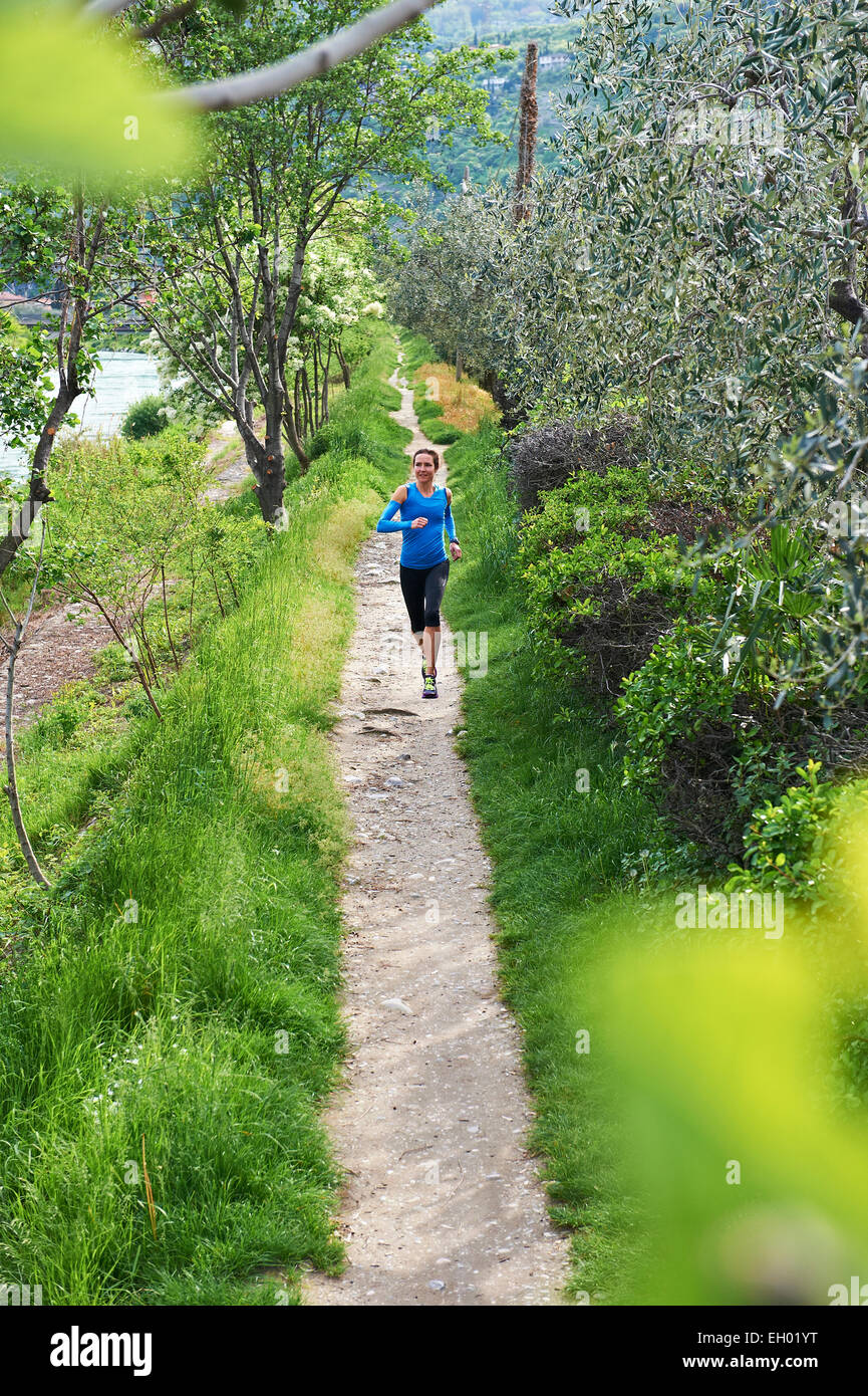 Italy, Trentino, woman running near Lake Garda Stock Photo - Alamy