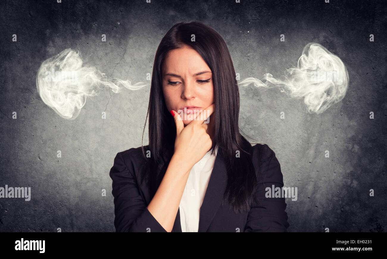Thoughtful woman with steam from ears. Concrete gray as backdrop Stock ...