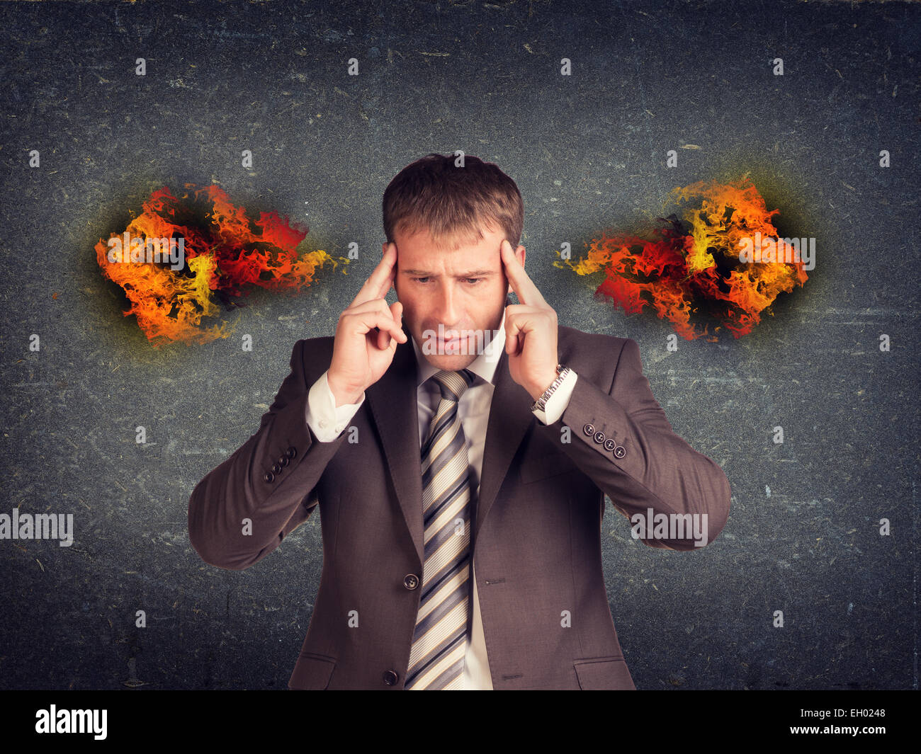 Thoughtful man with fire from ears. Concrete gray wall as backdrop ...