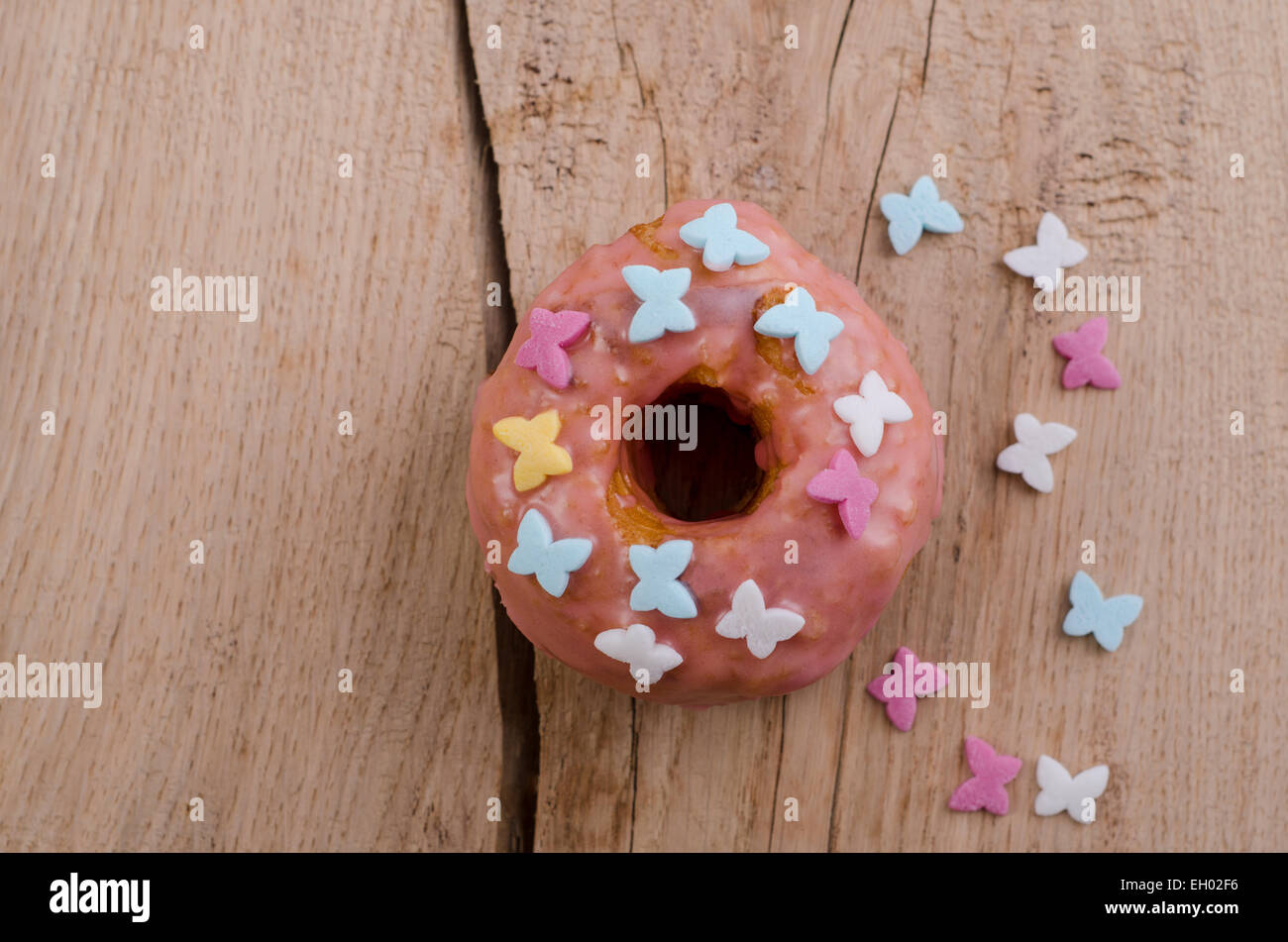 Cronut with icing on wooden table Stock Photo - Alamy