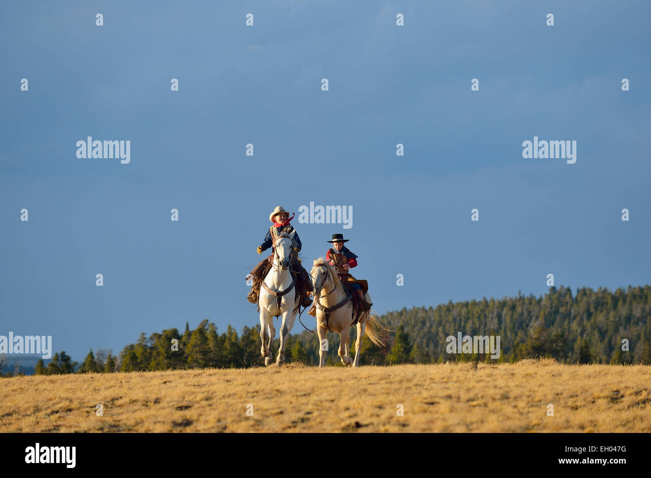 USA, Wyoming, two young cowboys riding Stock Photo - Alamy