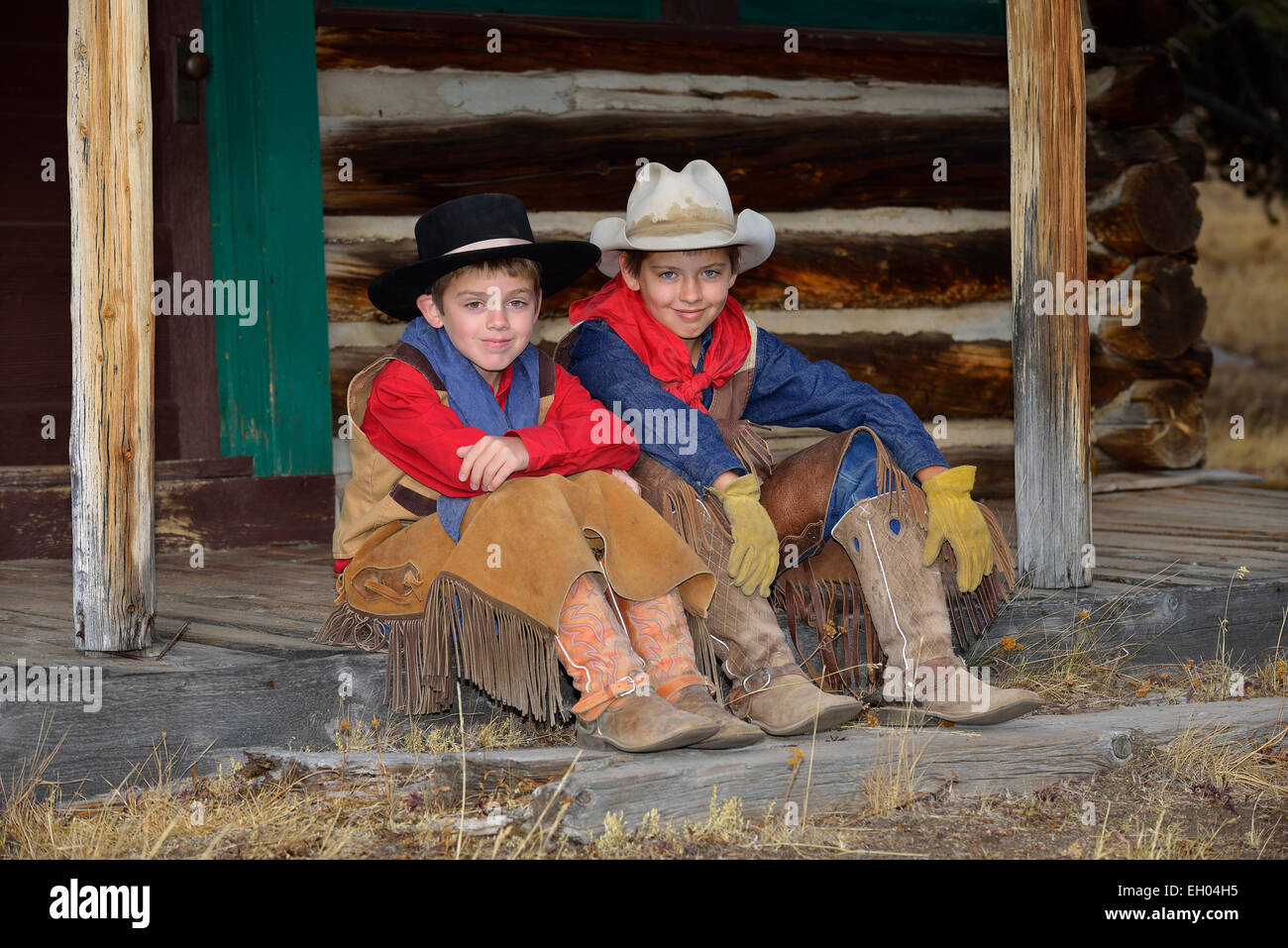 Two young cowboys sitting side by side hi-res stock photography and ...
