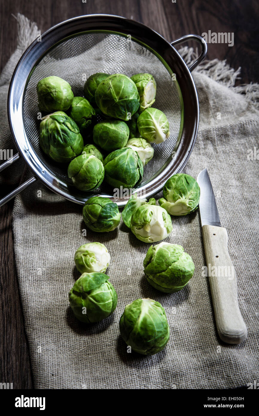 Brussel sprout in colander and knife Stock Photo - Alamy