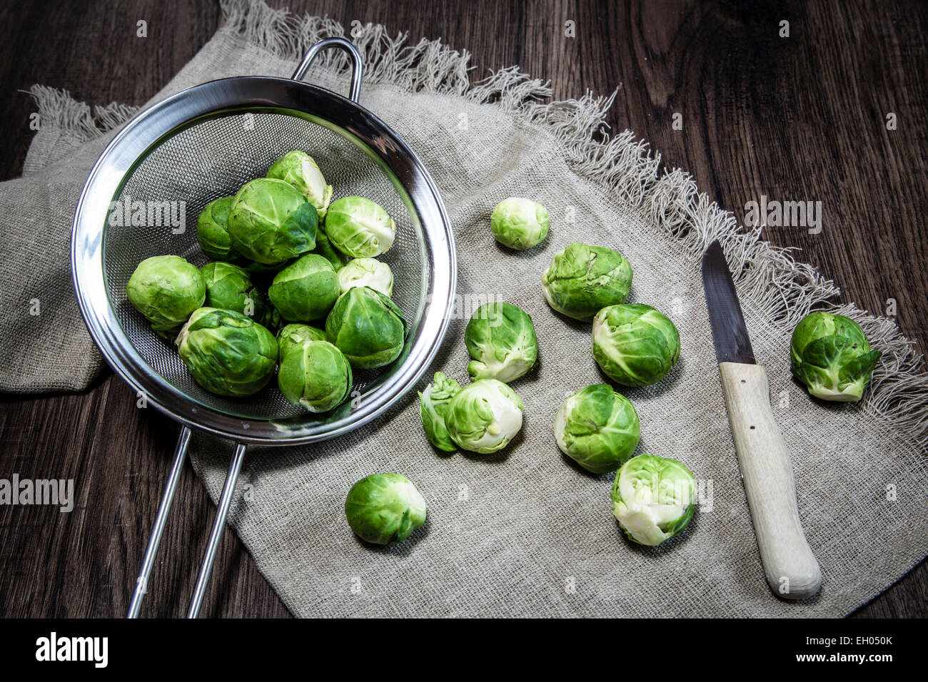 Brussel sprout in colander and knife Stock Photo - Alamy
