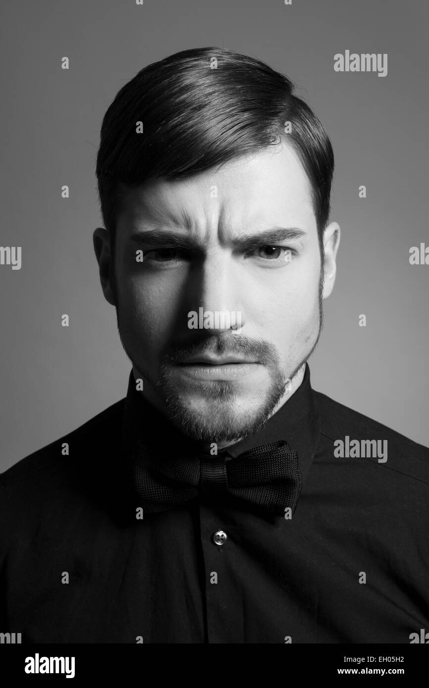 Portrait of serious looking man wearing black bow and black shirt Stock ...