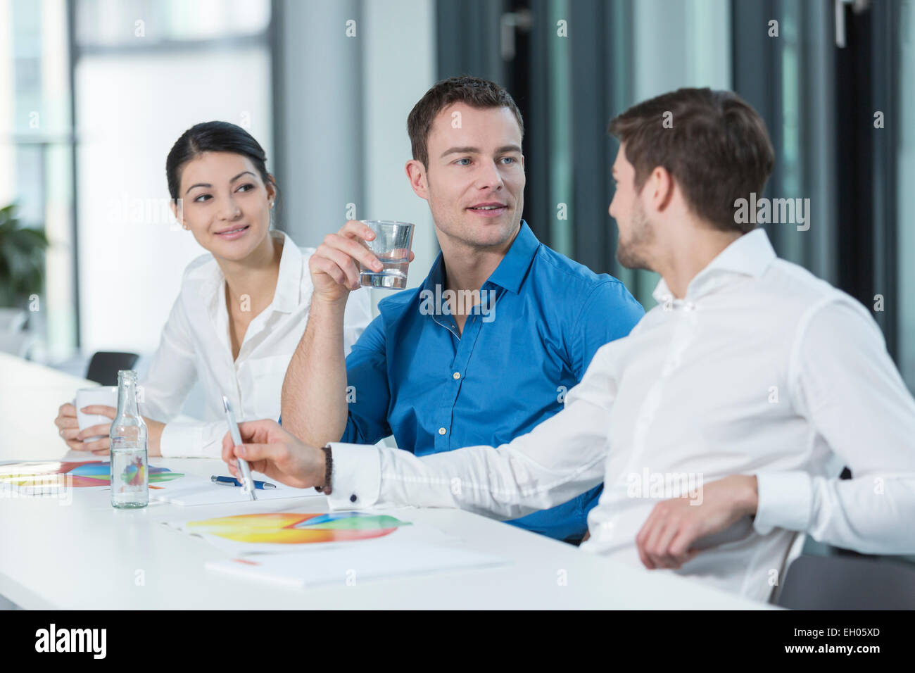 Three business people in a conference room Stock Photo - Alamy