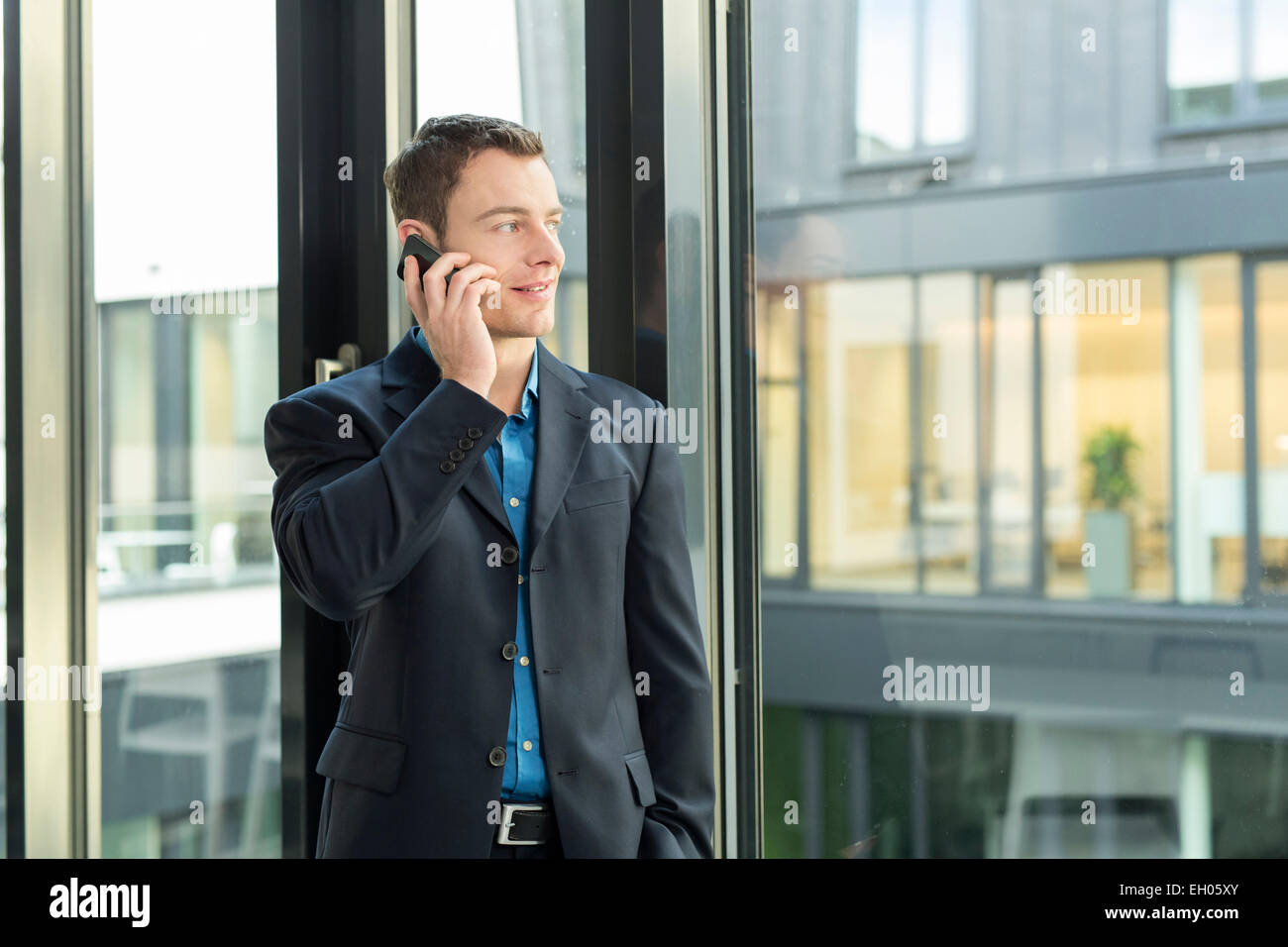 Businessman telephoning with smartphone in an office Stock Photo - Alamy