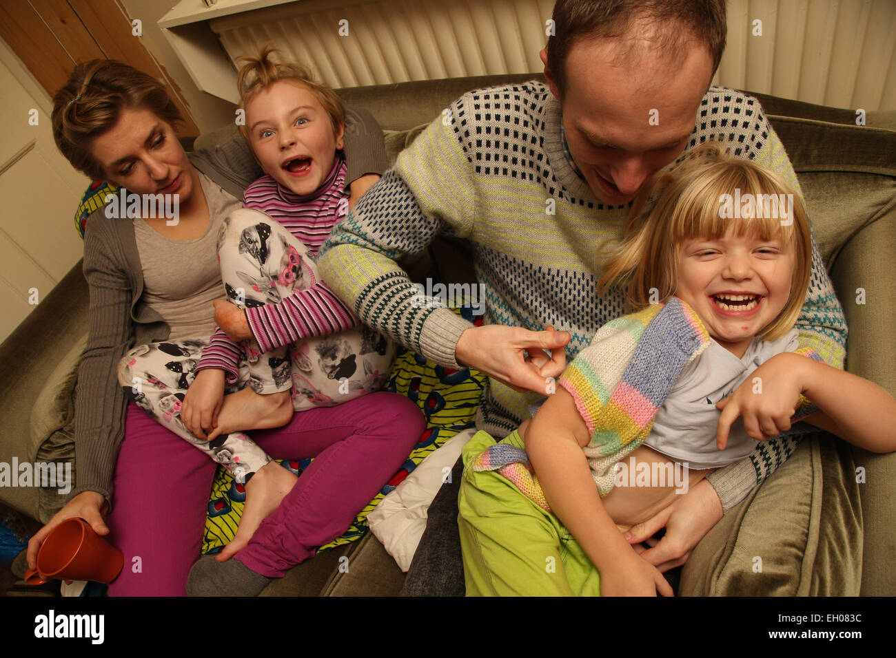 Family on sofa - model released Stock Photo - Alamy
