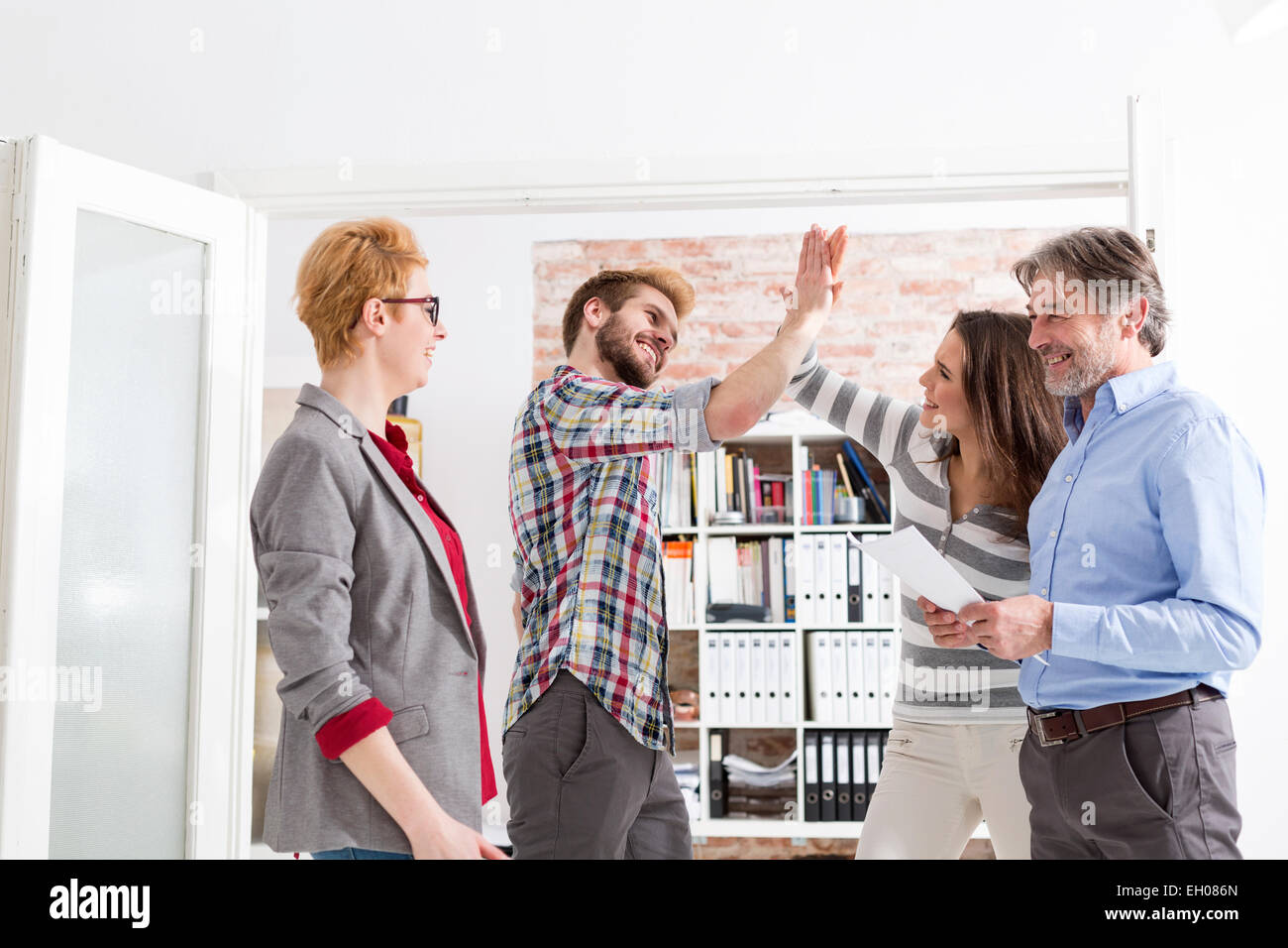 High fiving people hi-res stock photography and images - Alamy