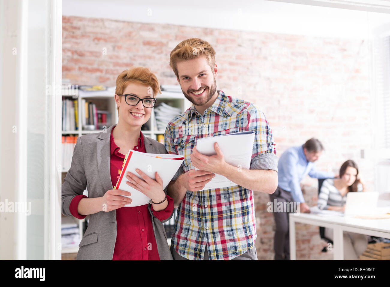 Portrait of two confident young colleagues in office Stock Photo - Alamy