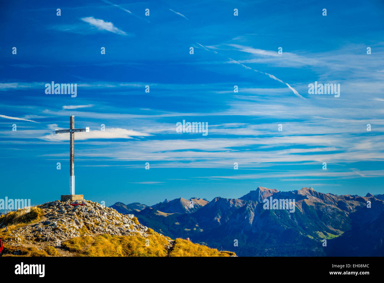 Austria, Allg├ñu alps, summit cross on Hahnenkoepfle in front of blue ...