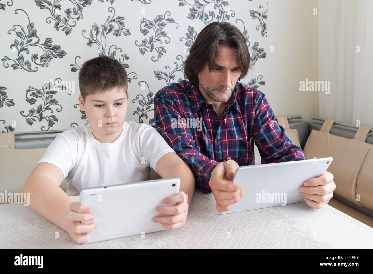 dad and son with tablet computer indoor Stock Photo - Alamy