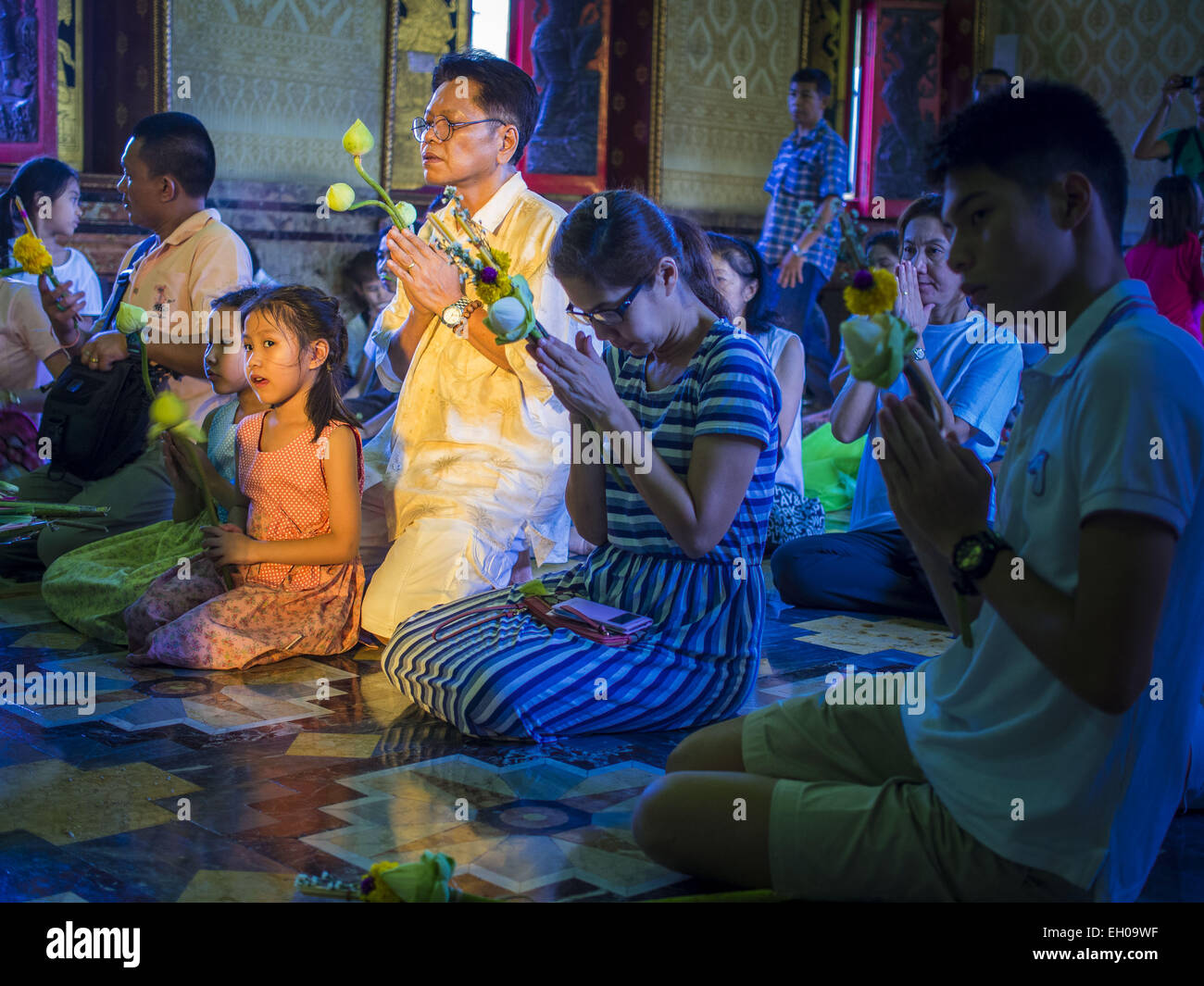 Bangkok, Thailand. 4th Mar, 2015. People pray in the ''wiharn'' or ...