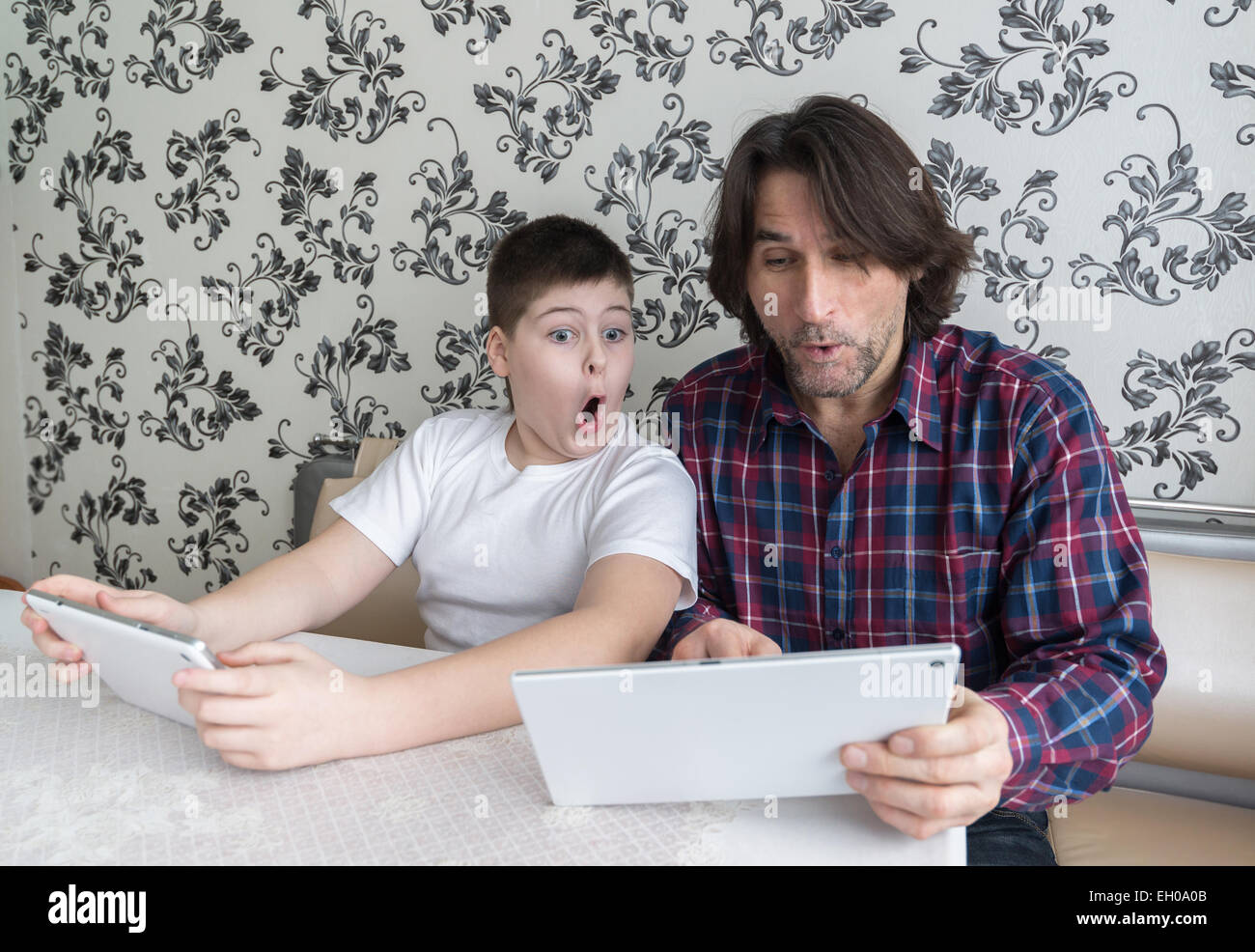 dad and son with tablet computer indoor Stock Photo - Alamy