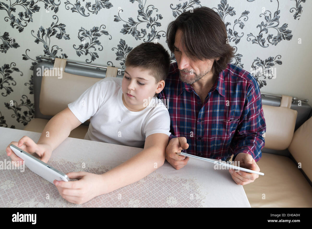 dad and son with tablet computer indoor Stock Photo - Alamy