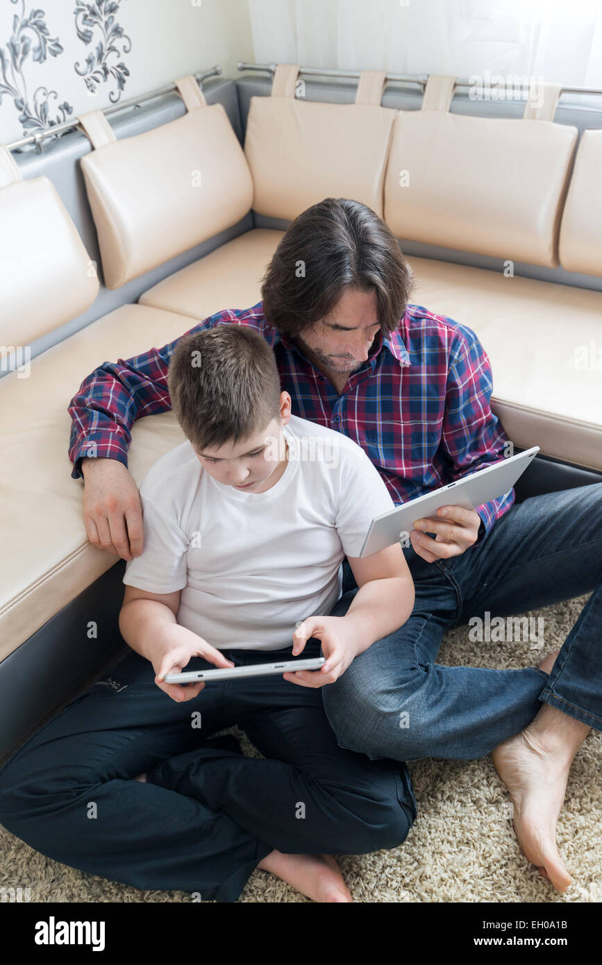 dad and son with tablet computer indoor Stock Photo - Alamy