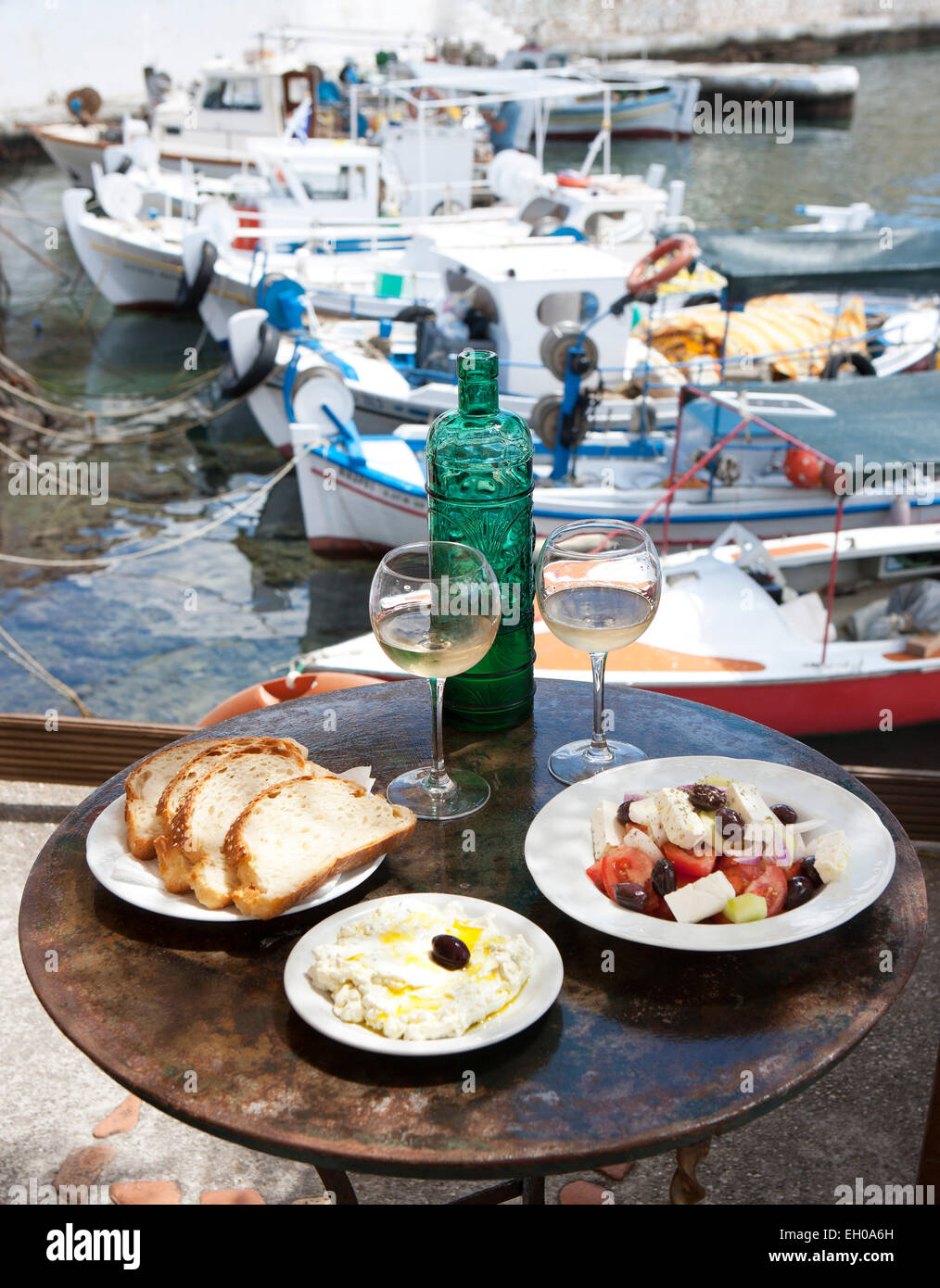 Greece, Agios Nikolaos, traditional Greek starters and wine on table ...