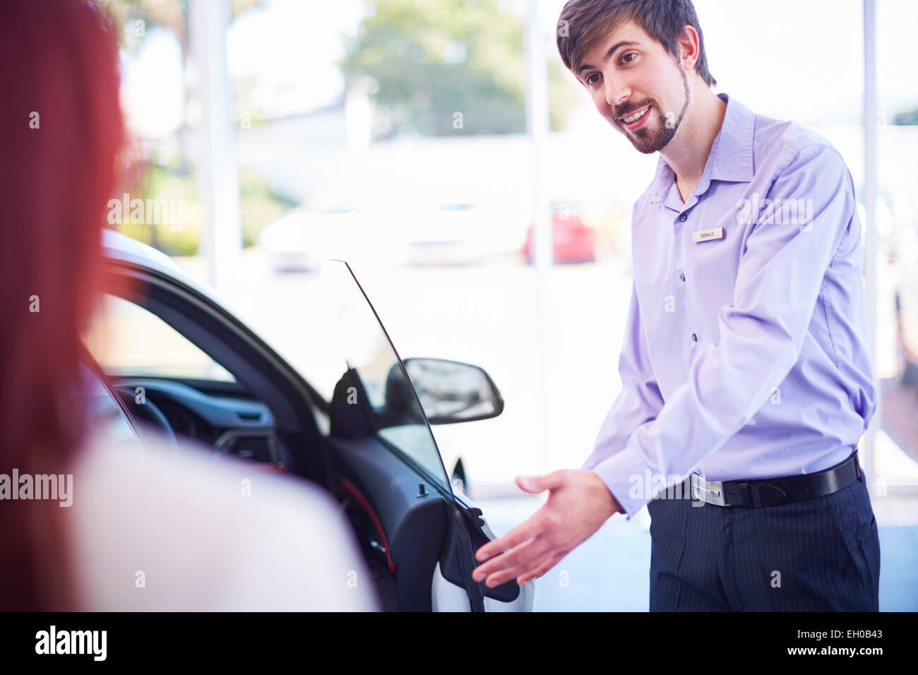 Car dealer talking to client Stock Photo - Alamy