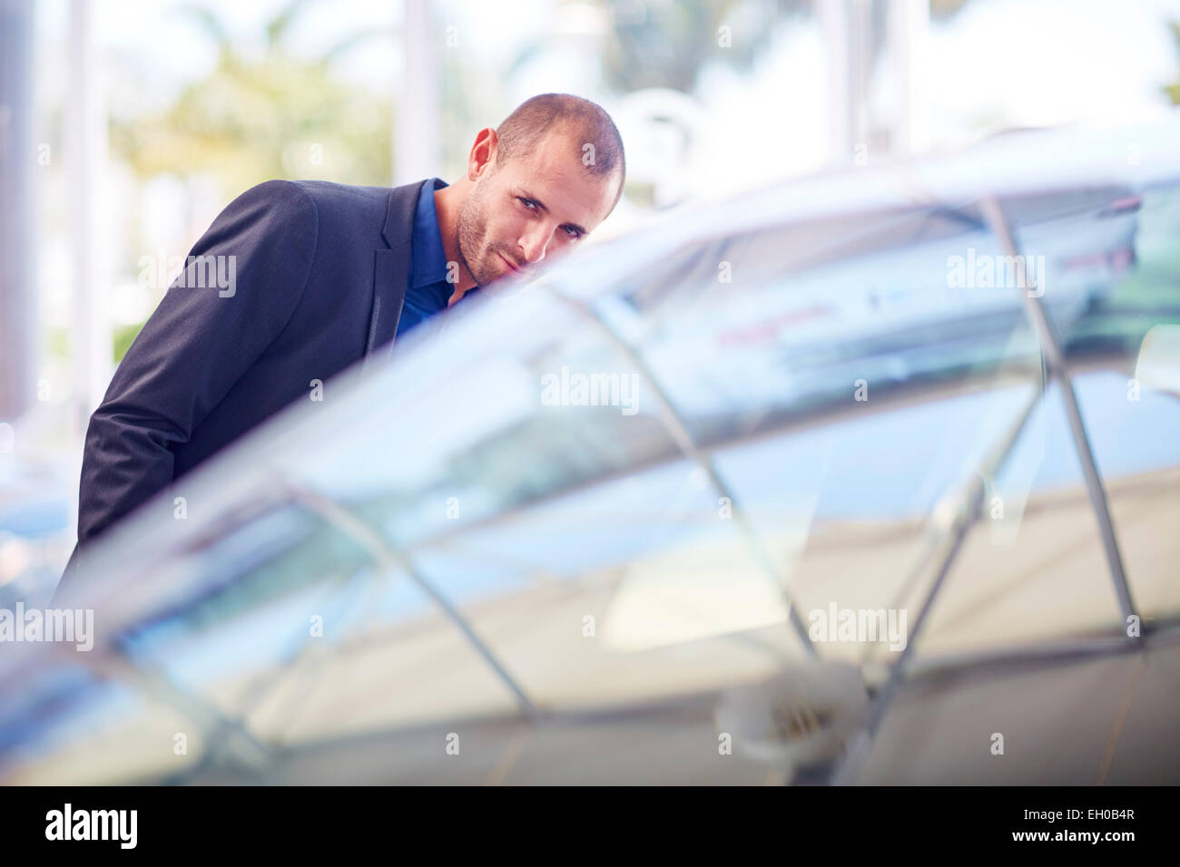 Client at car dealer looking at car Stock Photo - Alamy
