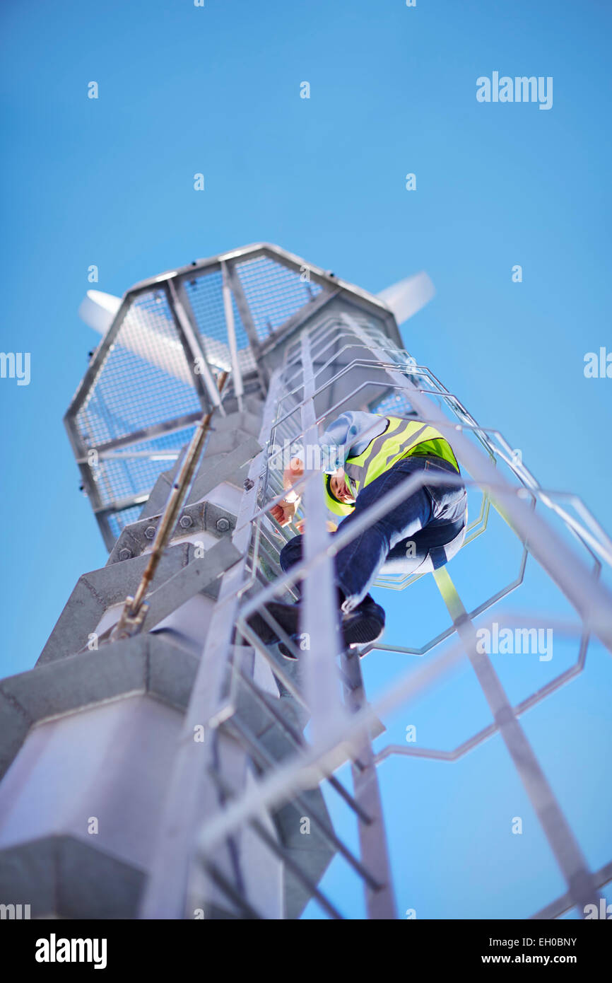Wind turbine engineer climbing on ladder Stock Photo - Alamy