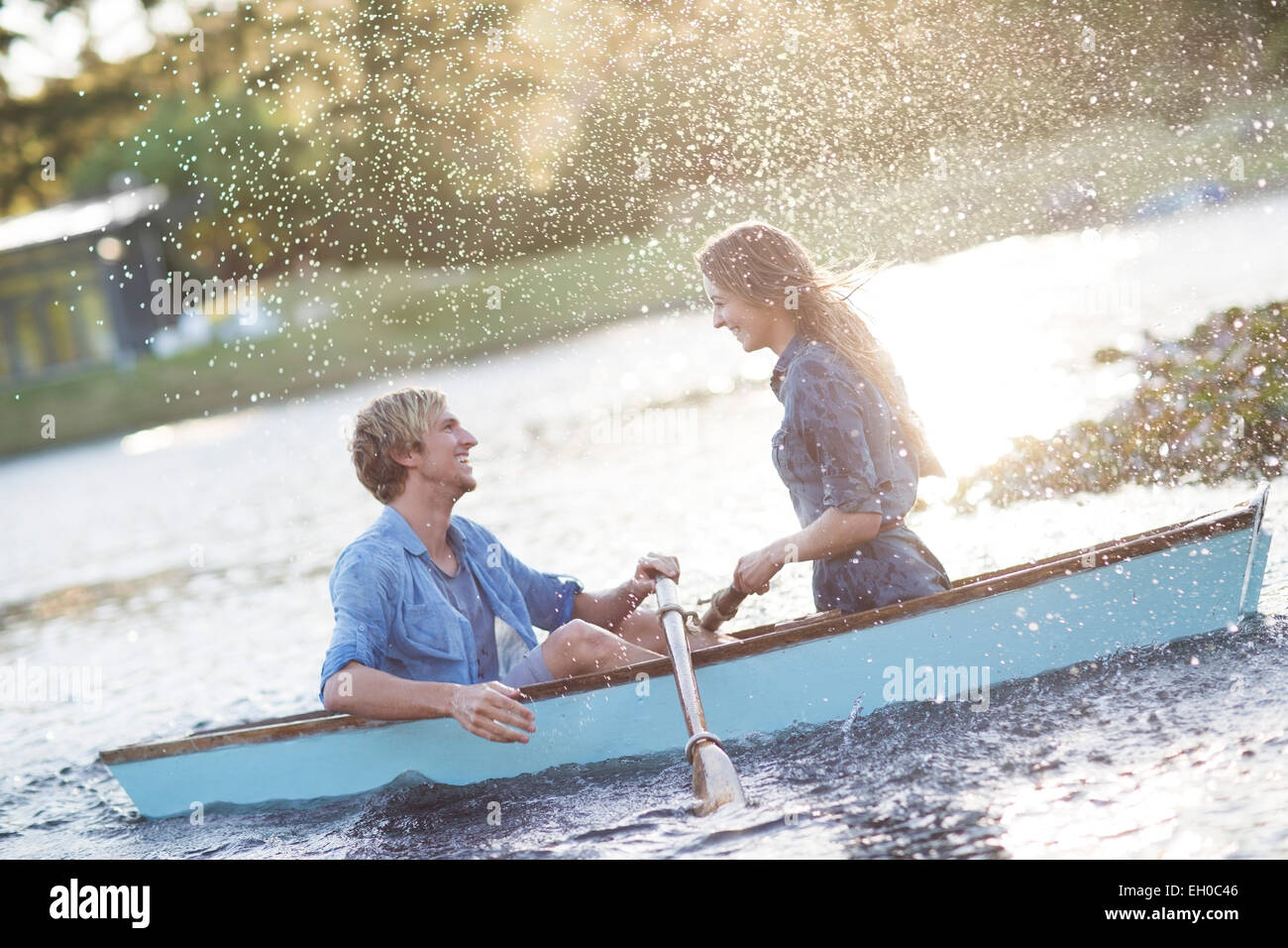 Young couple in a rowing boat on a lake Stock Photo - Alamy