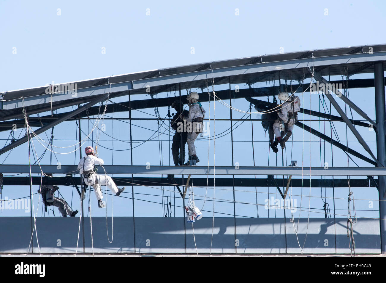 Men working on side of building Stock Photo - Alamy