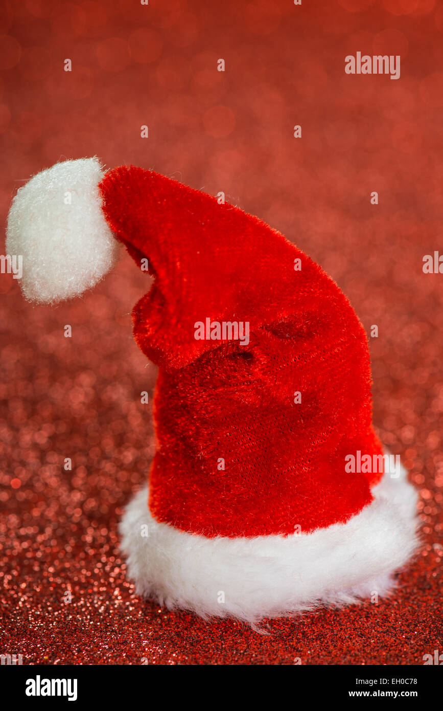 Little santa claus hat on red background Stock Photo - Alamy