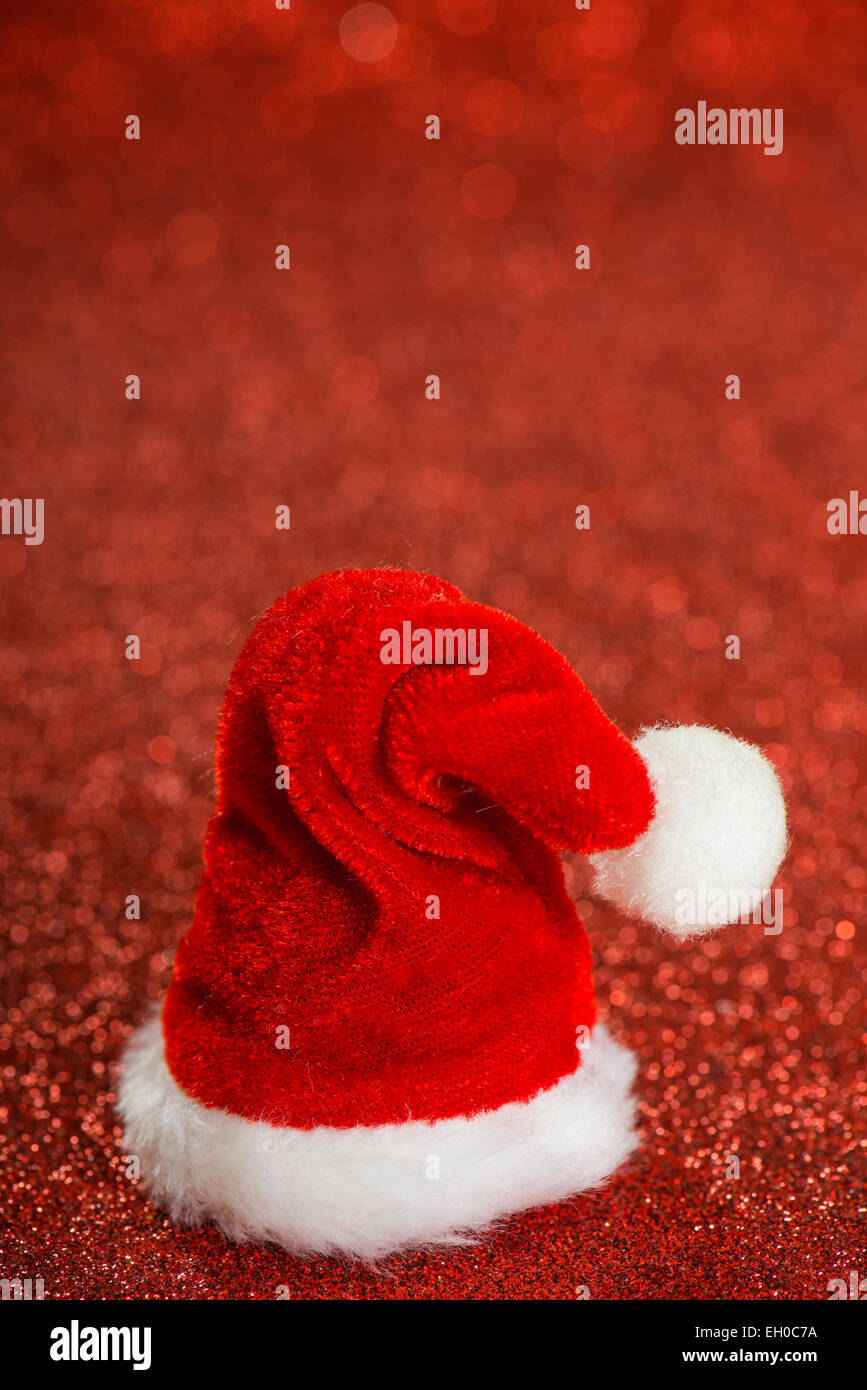Little santa claus hat on red background Stock Photo - Alamy